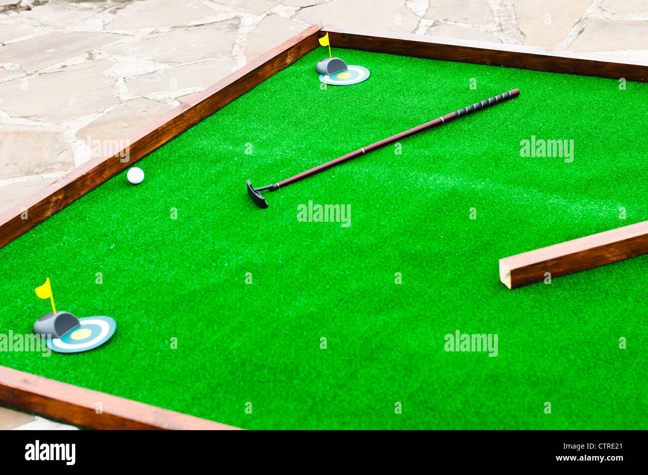 Mini golf field with ball and golf club Stock Photo - Alamy