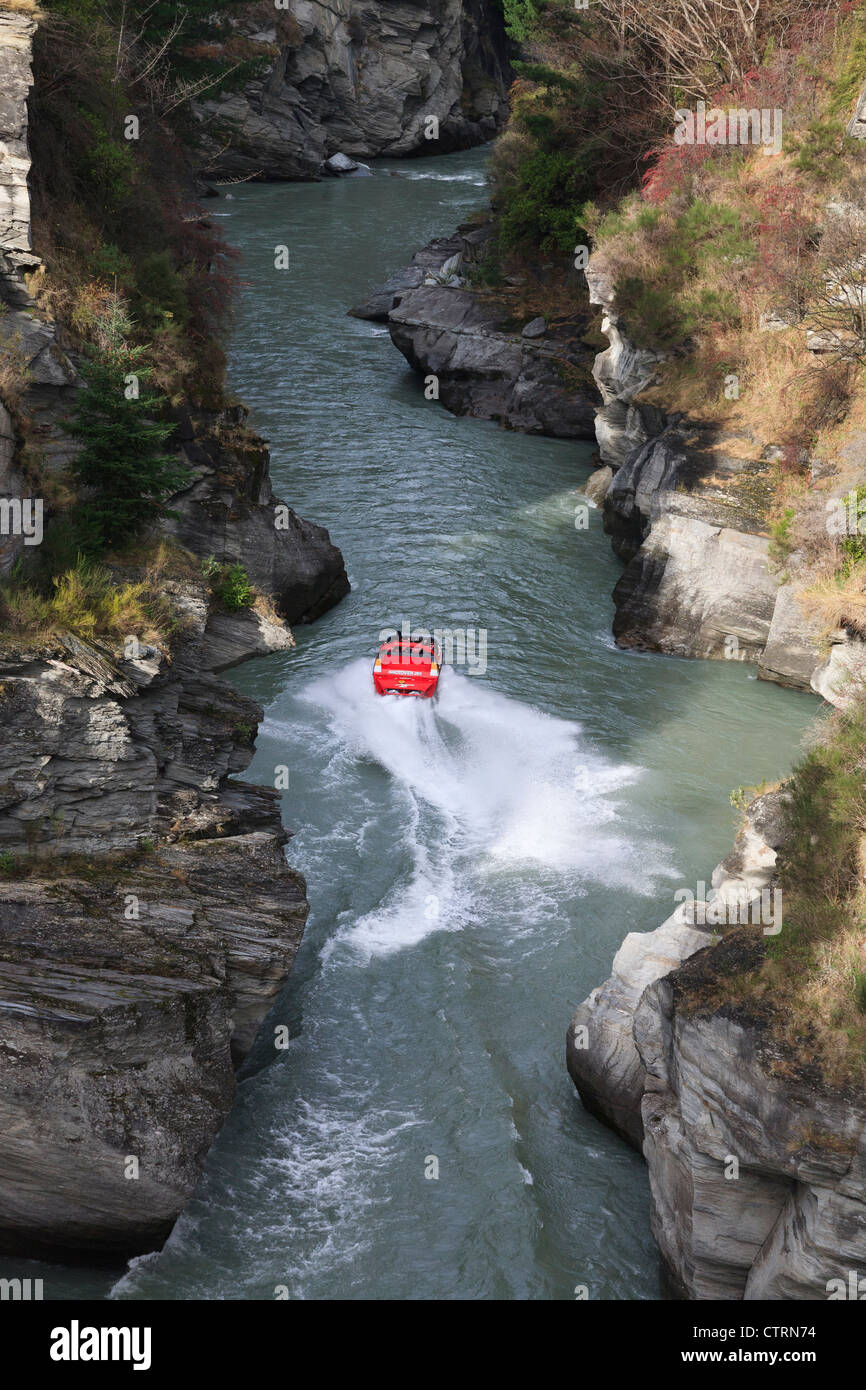 High view down to Shotover River canyon with Shotover jet boat giving ...