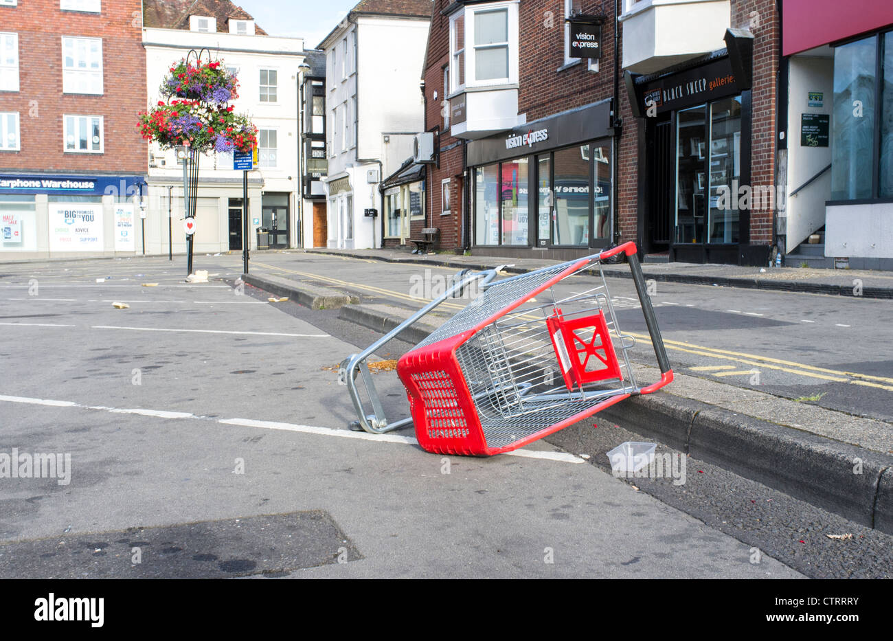 Abandoned shopping trolley left on its side in a UK street Stock Photo ...