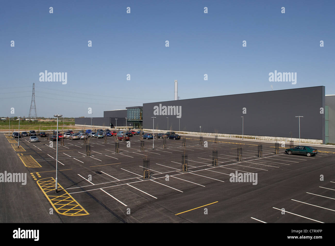 project orange view across car park to factory Stock Photo - Alamy