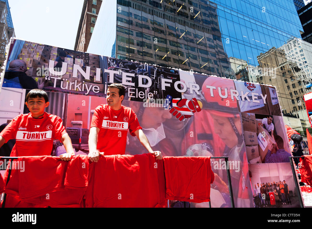 Two Turkish men standing in front of sign saying United for Turkey on ...