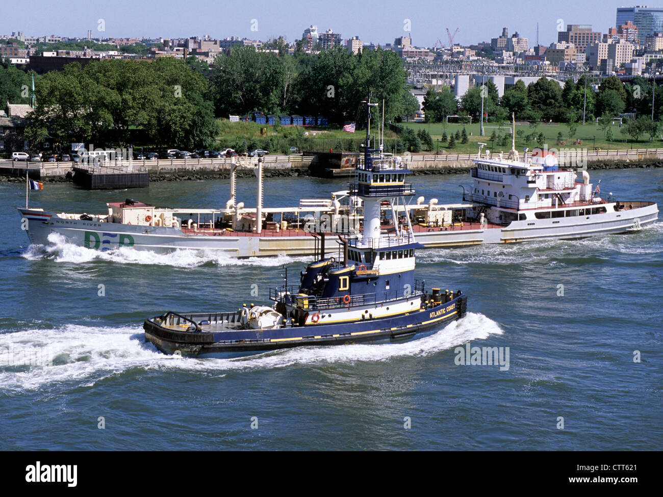 New York East River tugboat, passing Department of Environmental ...