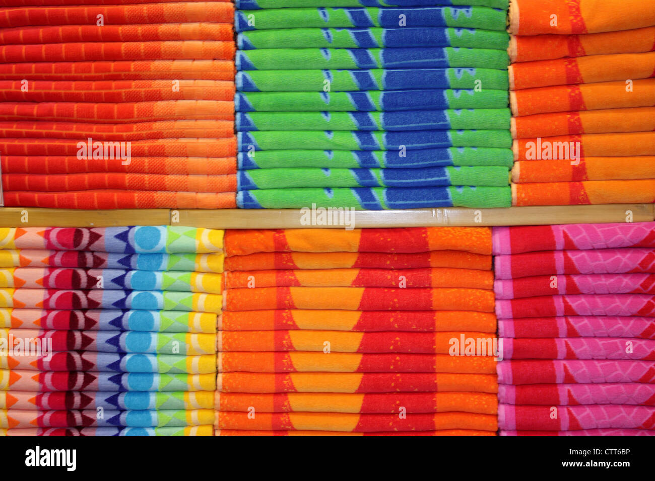 Colorful towels on shelf in a store Stock Photo - Alamy