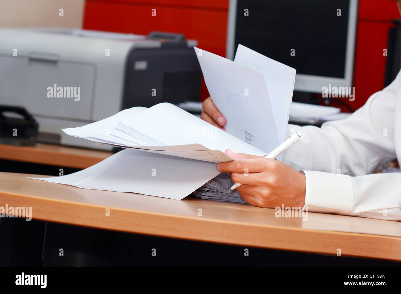 a worker man analyzing pile of paper Stock Photo - Alamy