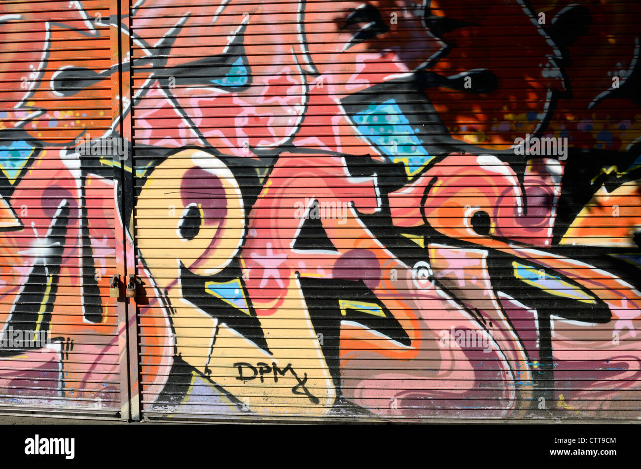 Colourful graffiti on shop shutter Stock Photo - Alamy