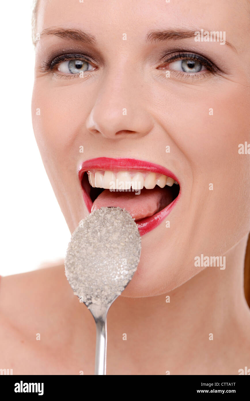 woman licking white sugar off a spoon Stock Photo - Alamy