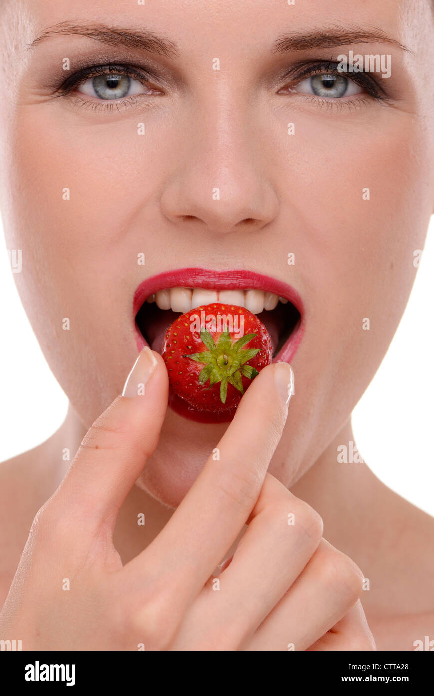 woman biting into a strawberry Stock Photo - Alamy