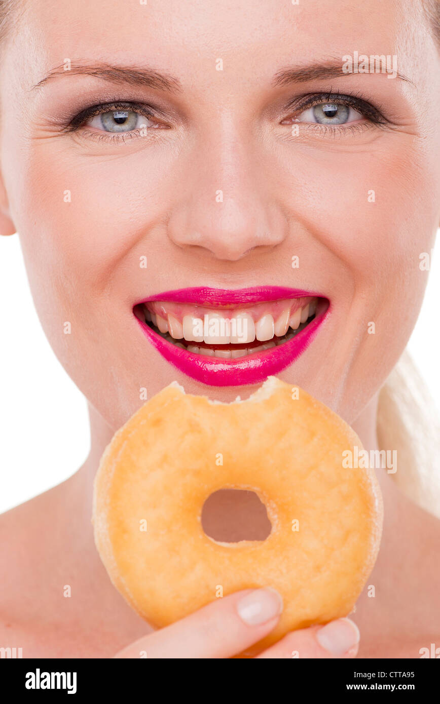 woman biting into a ring donut Stock Photo - Alamy