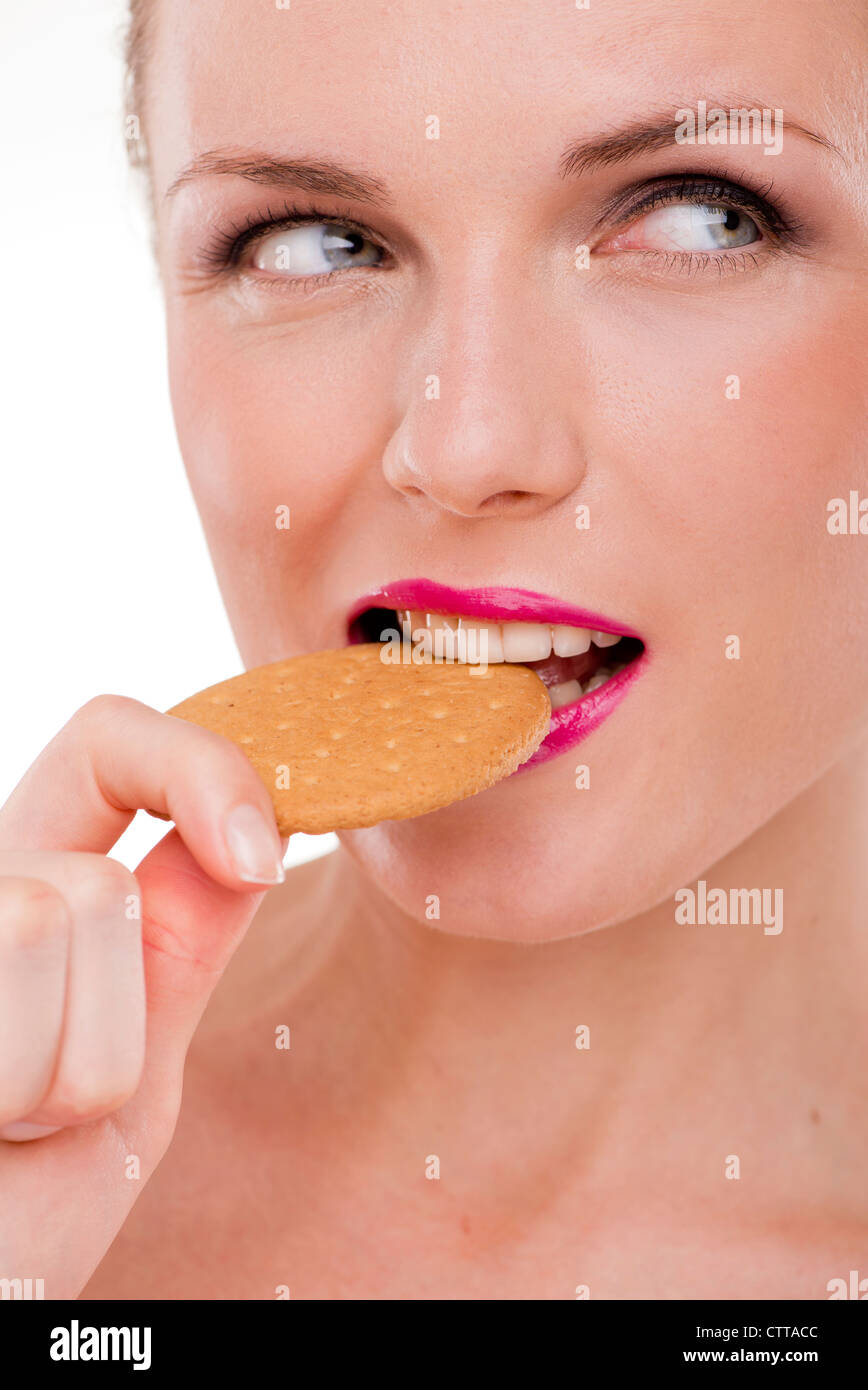 woman biting into digestive biscuit Stock Photo - Alamy