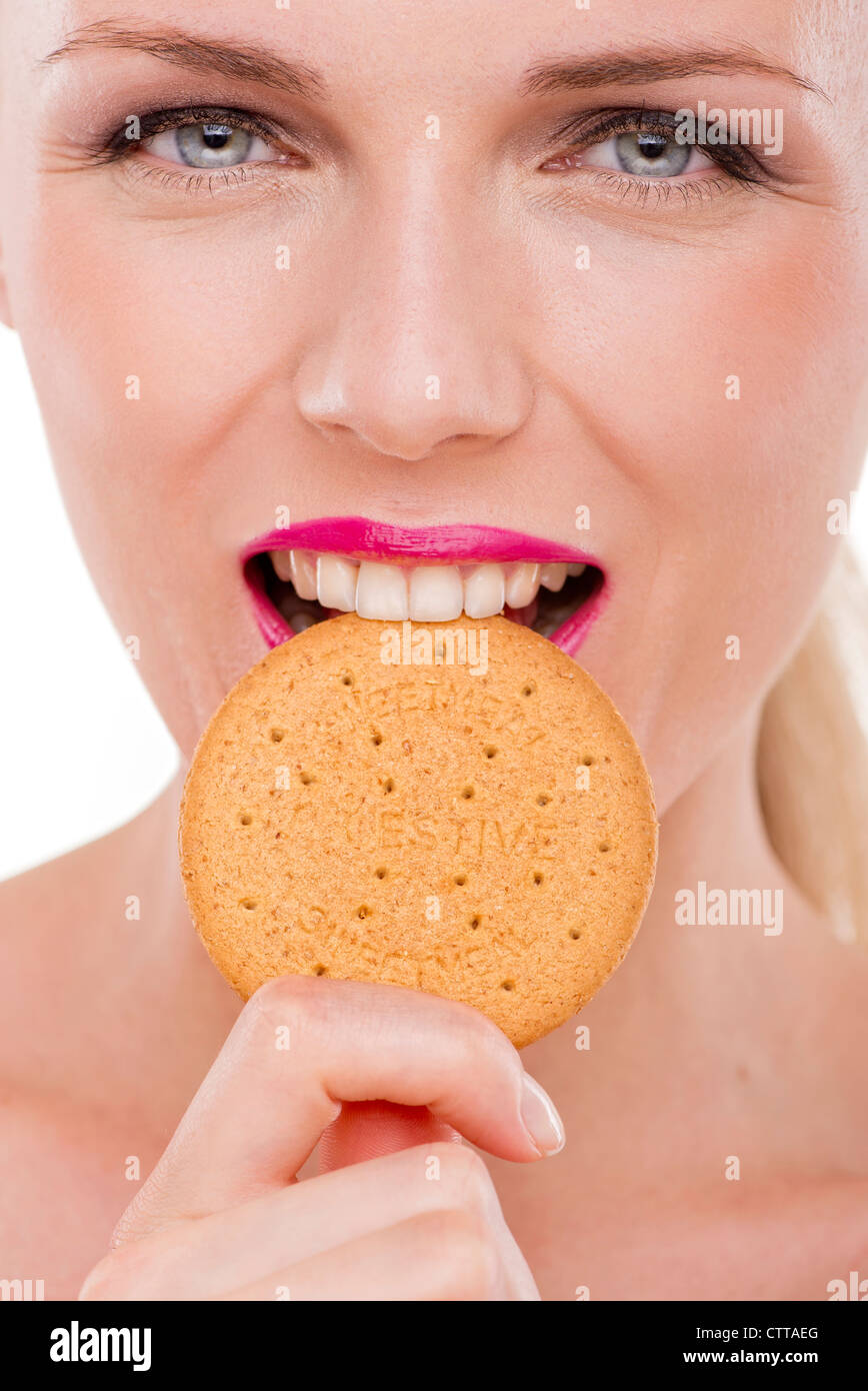 woman biting into digestive biscuit Stock Photo - Alamy