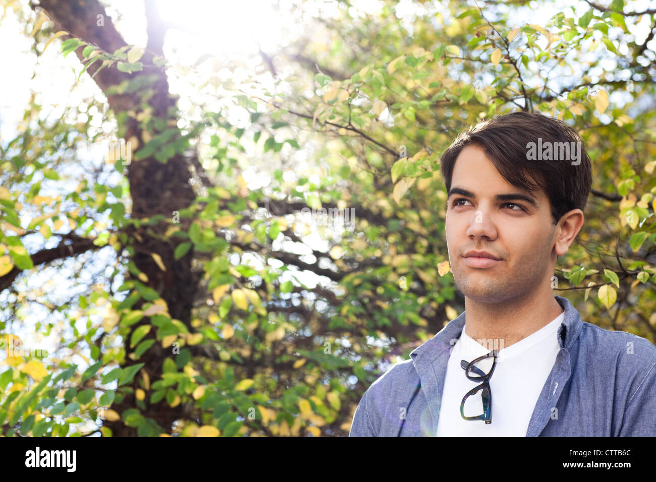 Handsome young man looking with curiosity Stock Photo - Alamy