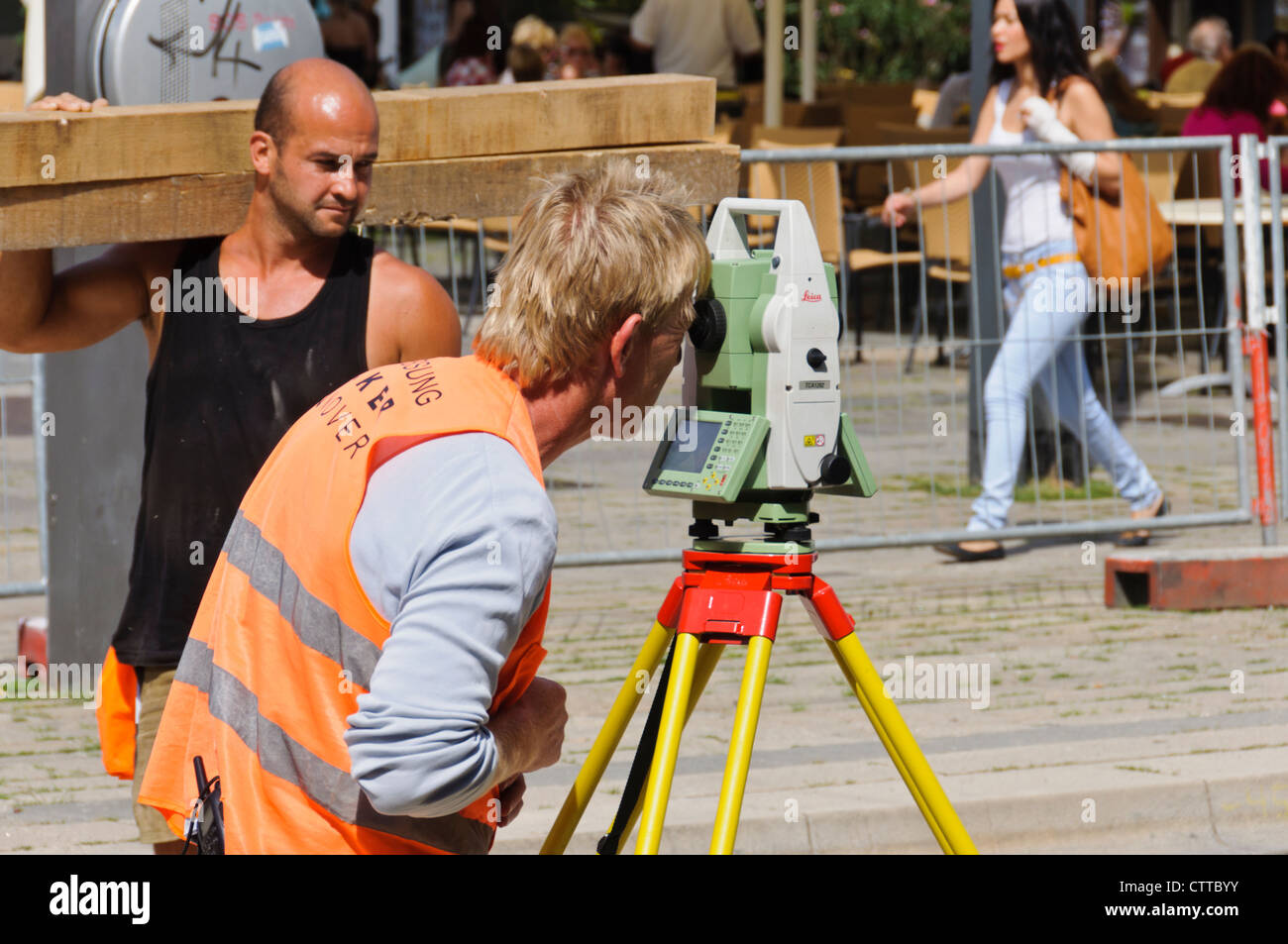 Geodesist land surveyor measures track construction site with modern up ...