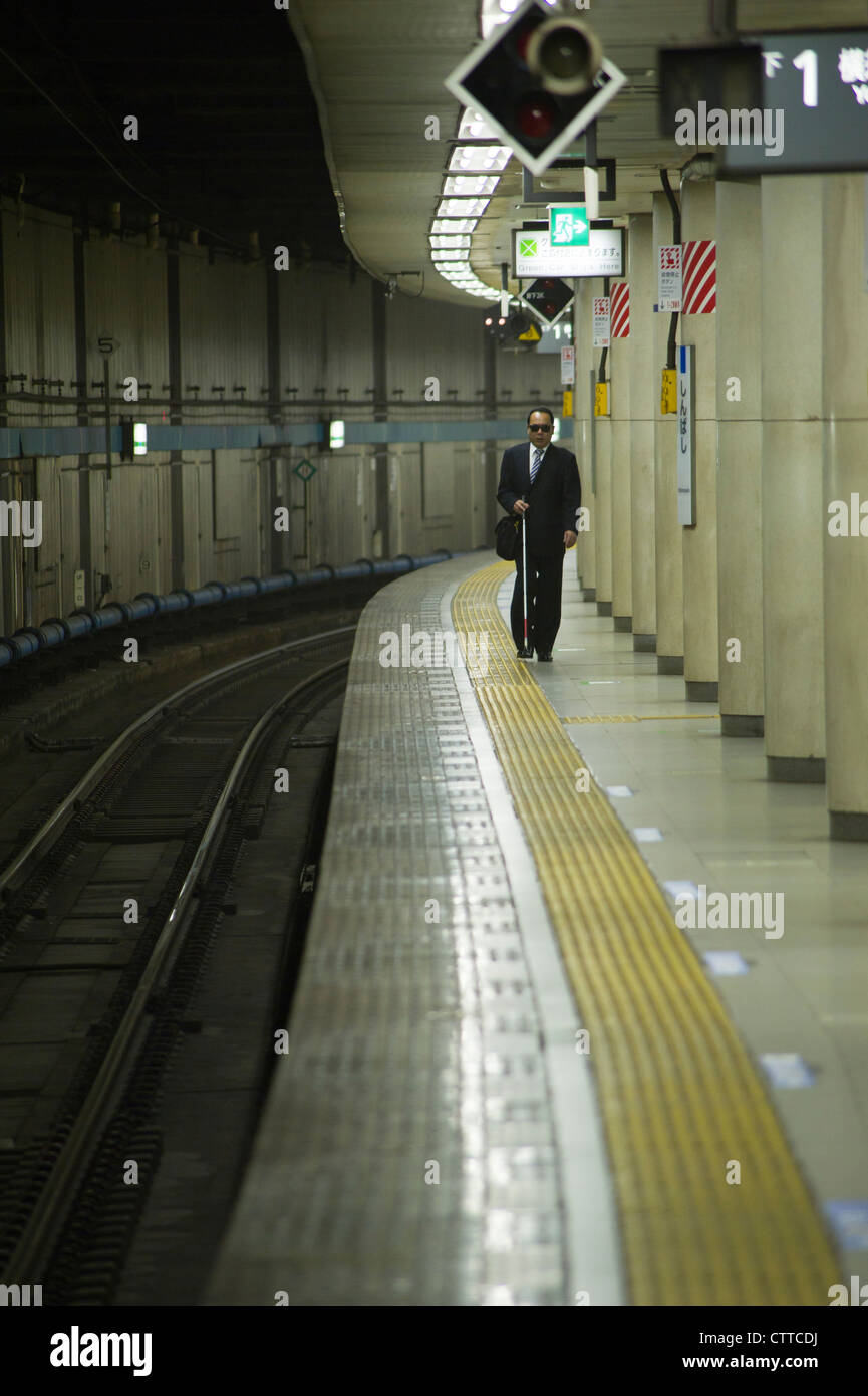Blind man on a JR train platform in Tokyo Stock Photo - Alamy