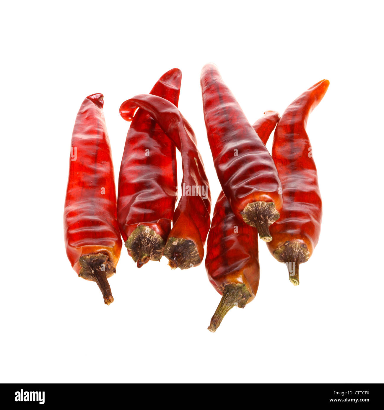 Six dried red hot chili peppers isolated against a white background ...
