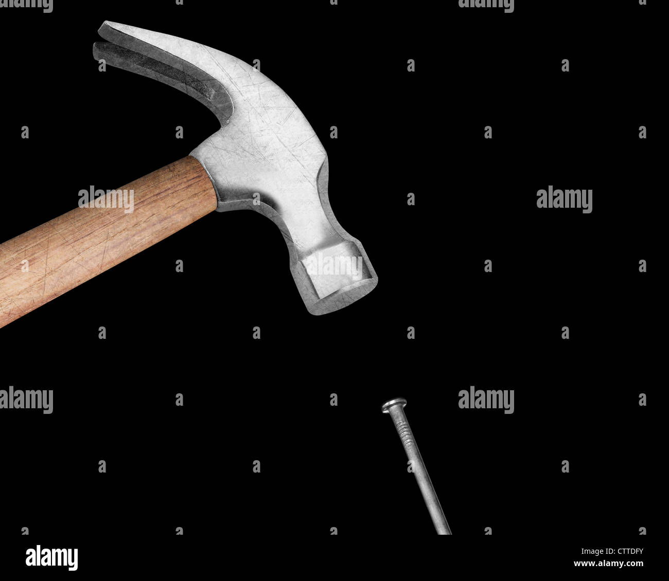 Hammer hitting a nail on black background Stock Photo - Alamy