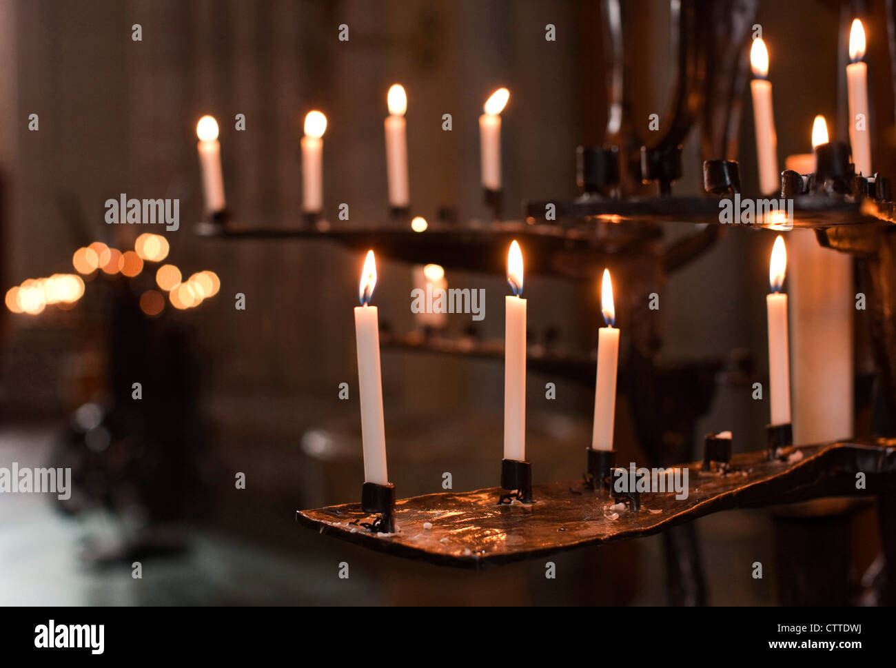Lit candles on an iron candelabra in Uppsala's cathderal. Sweden Stock ...
