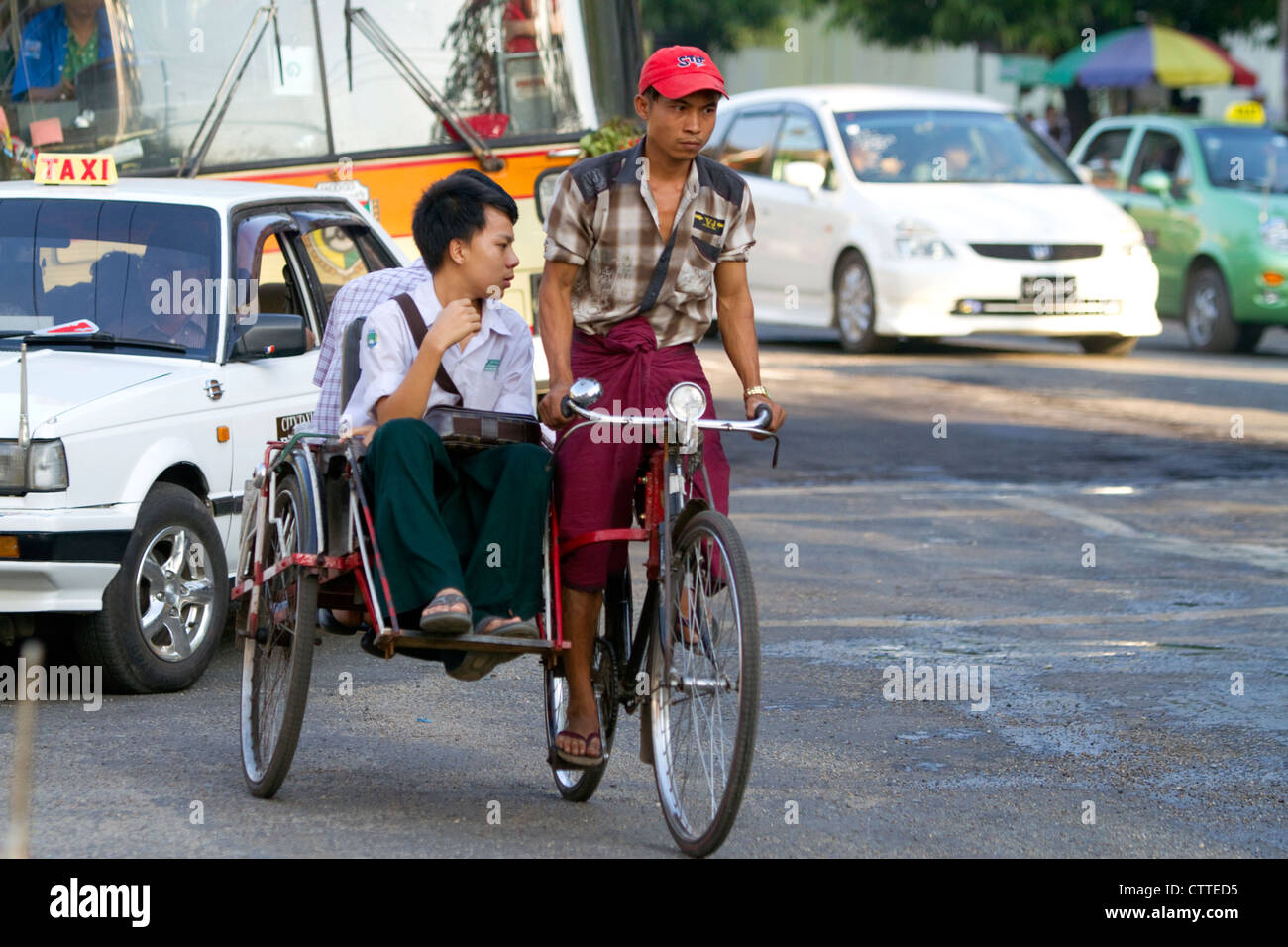 Passengers riding in a trishaw in (Rangoon) Yangon, (Burma) Myanmar ...