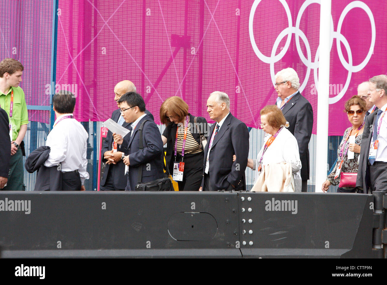 IOC Olympic delegates queue outside the Hilton Hotel for buses to take ...