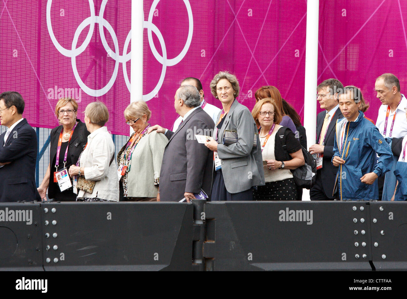IOC Olympic delegates queue outside the Hilton Hotel for buses to take ...