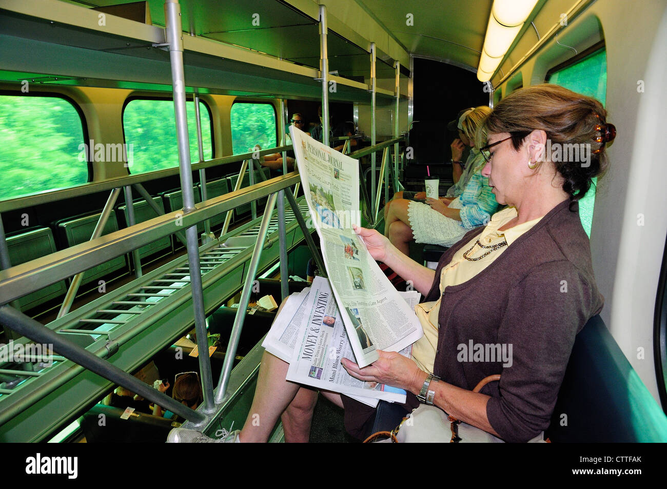 Woman Commuter Train Newspaper High Resolution Stock Photography and ...