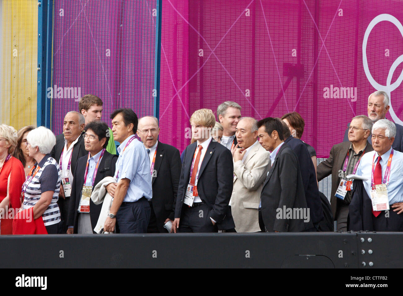 IOC Olympic delegates queue outside the Hilton Hotel for buses to take ...