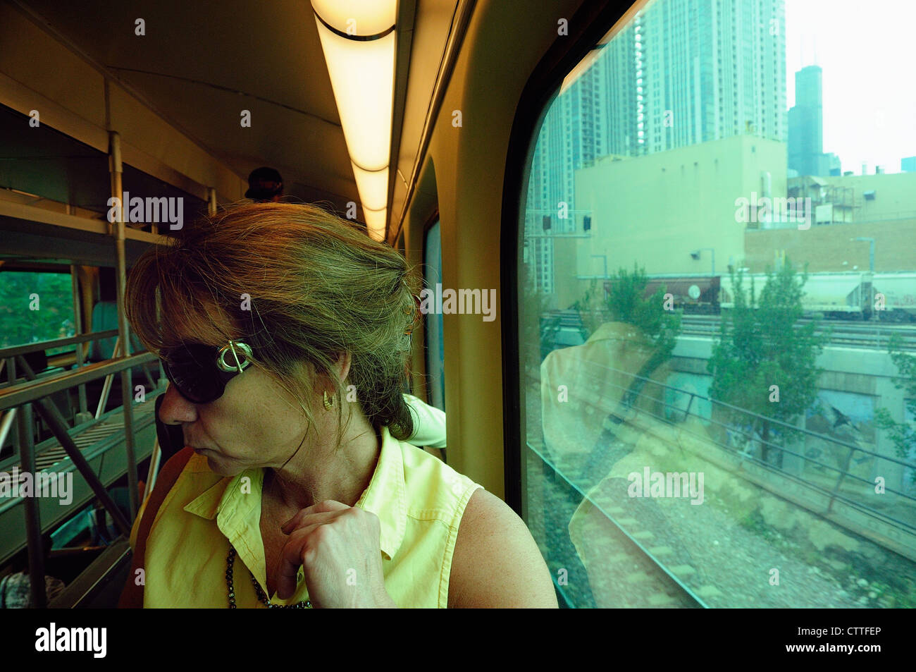 Middle aged woman riding on train Stock Photo - Alamy