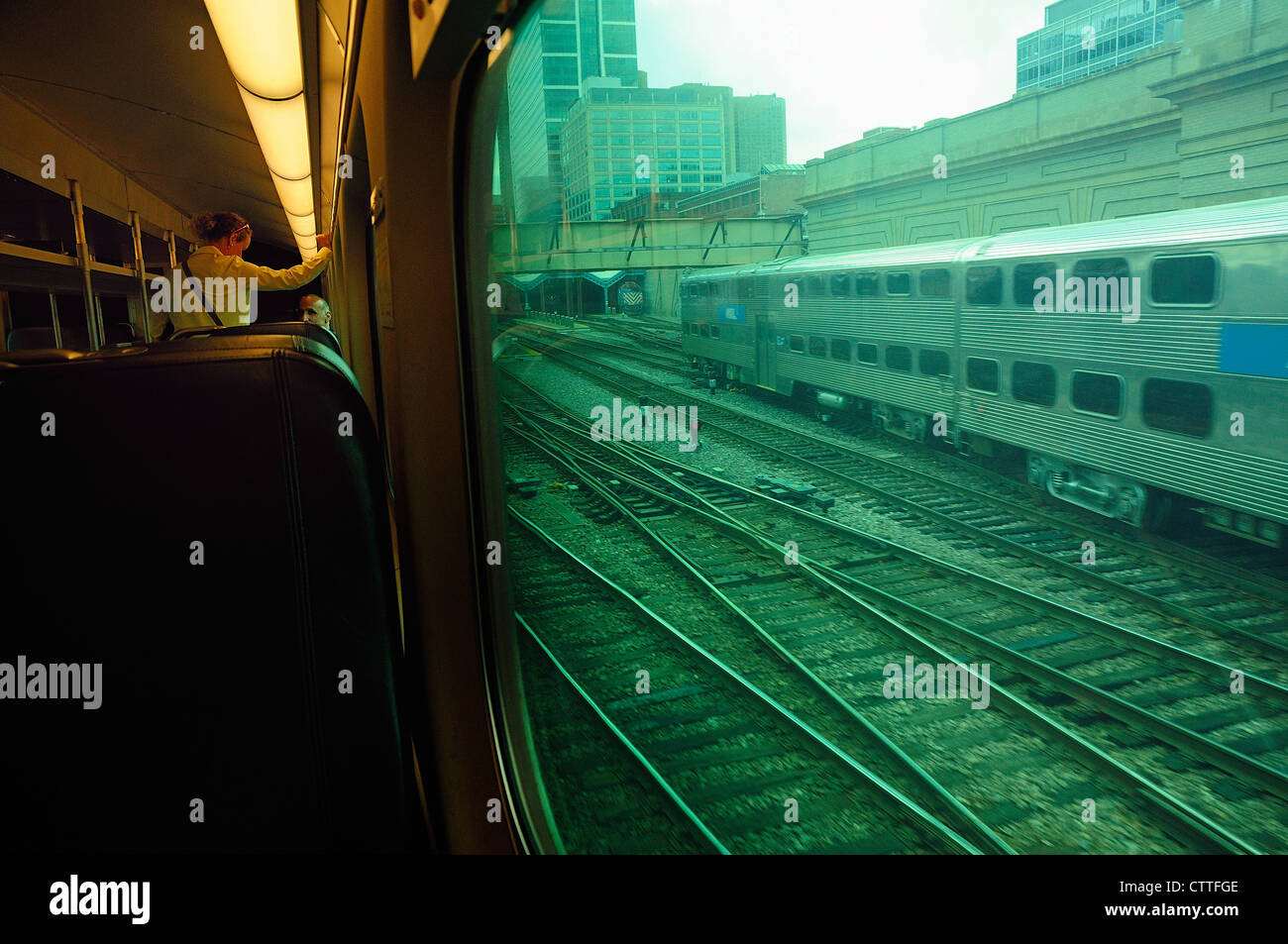 Passengers view outside window of a moving train with mysterious couple ...