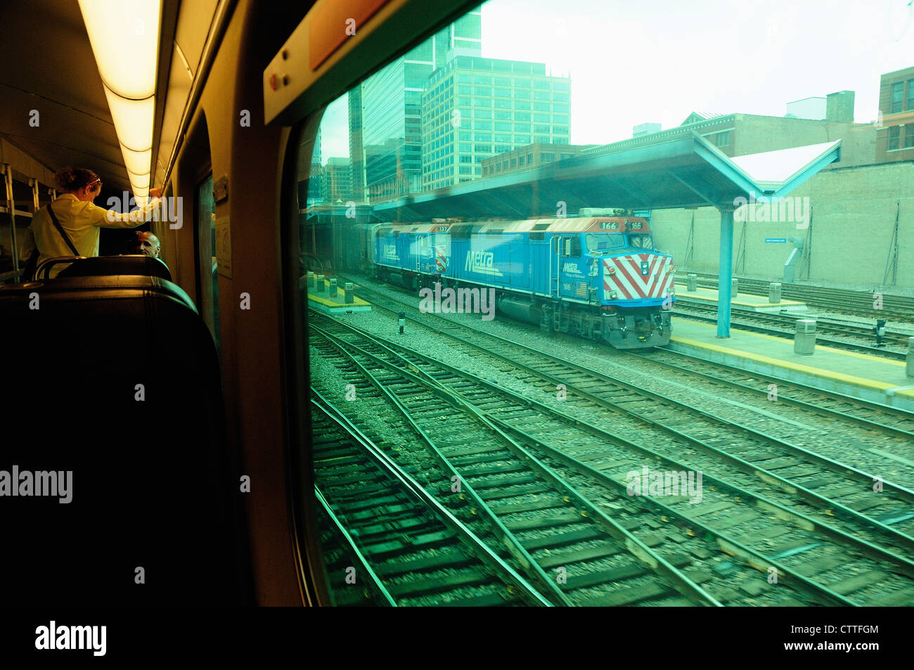 Passengers view outside window of a moving train with mysterious couple ...