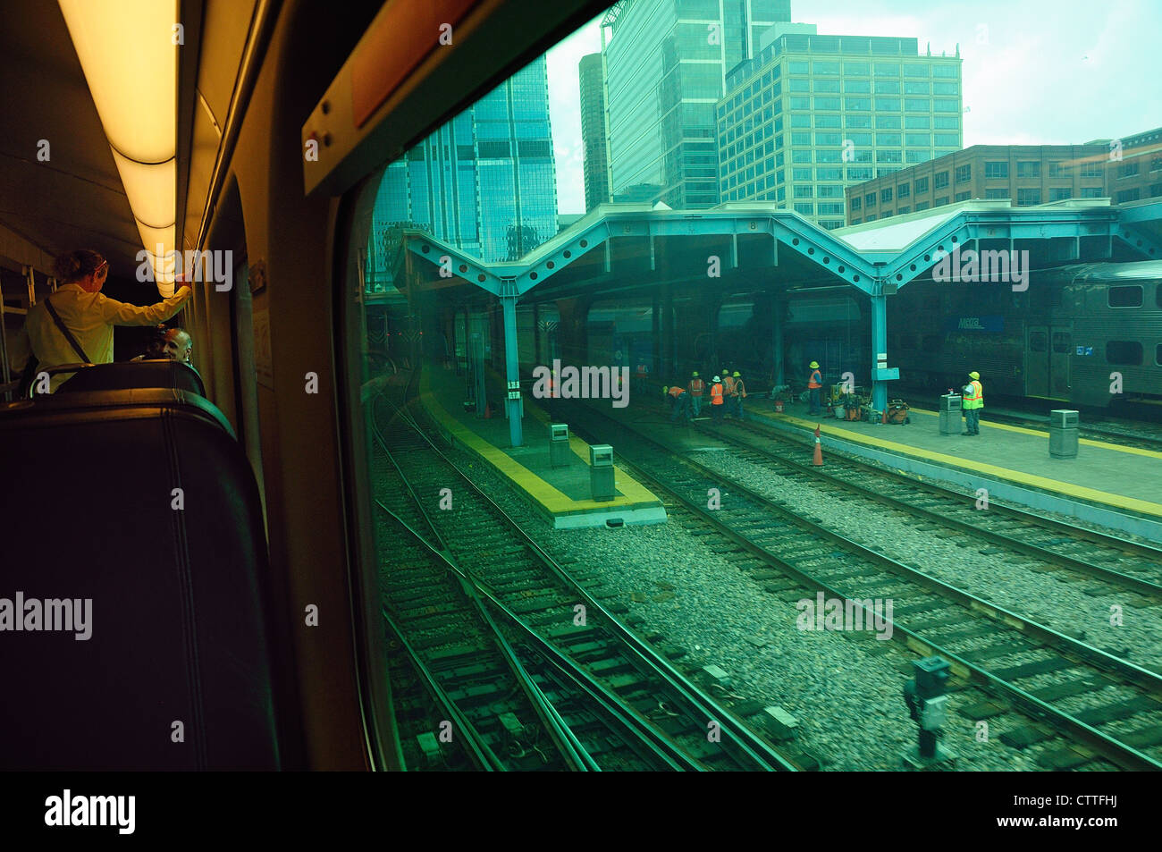 Passengers view outside window of a moving train with mysterious couple ...