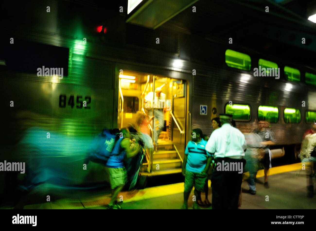 Train station platform with commuters and passengers moving on and off ...