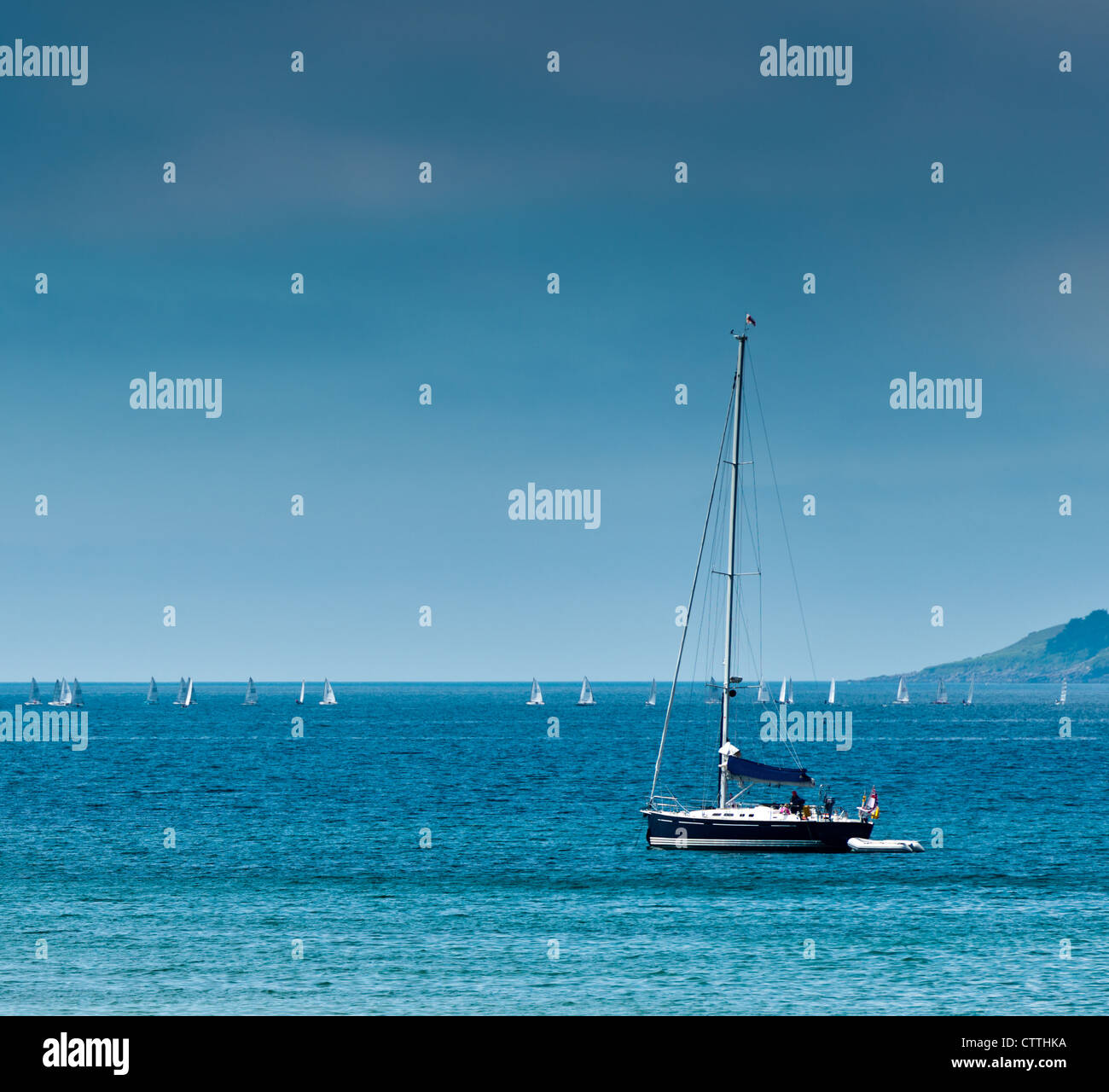 A small sail boat in the turquoise Cornish sea at Marazion, Cornwall ...