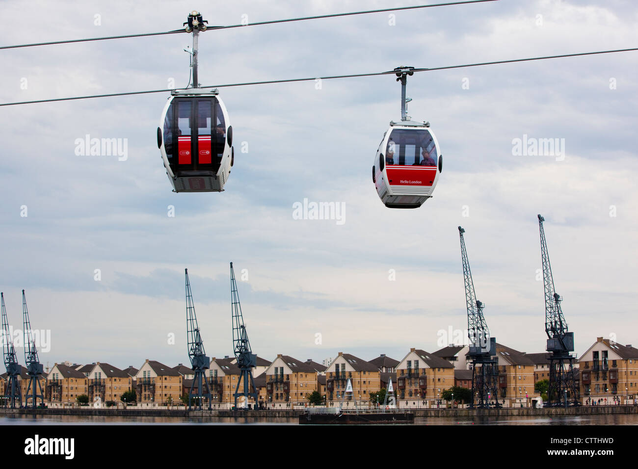 Cable cars spanning the Thames River where passengers cross between ...