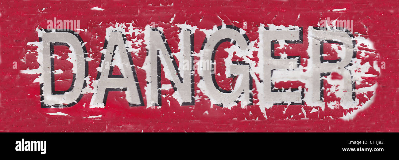a worn and damaged danger sign Stock Photo - Alamy