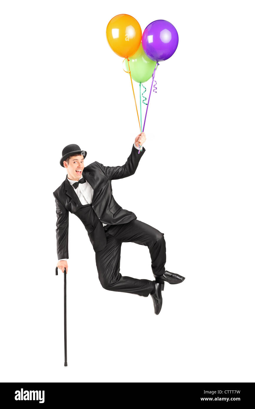 Magician flying up in the air and holding balloons isolated on white ...