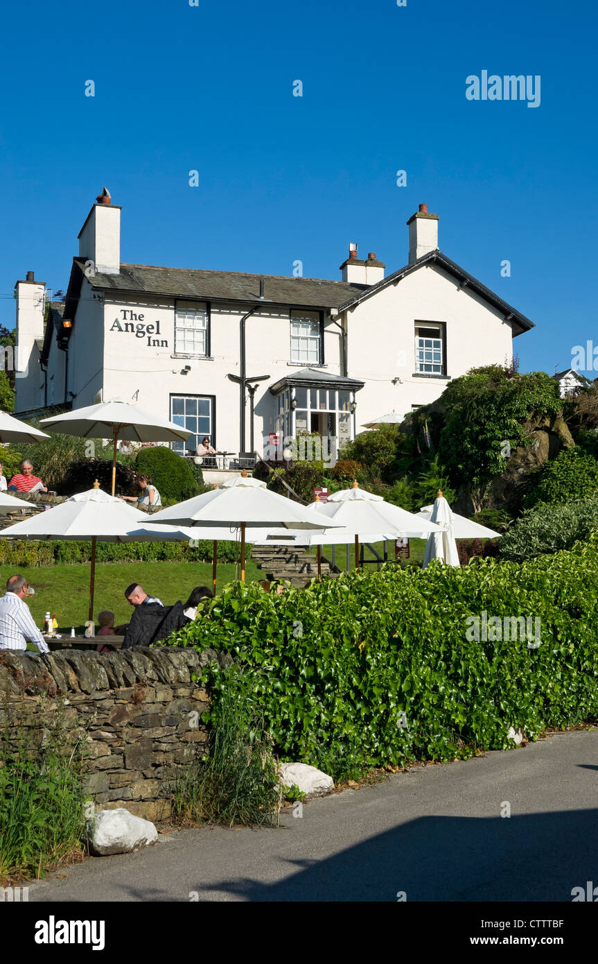 People visitors tourists sitting outside The Angel Inn pub in summer ...