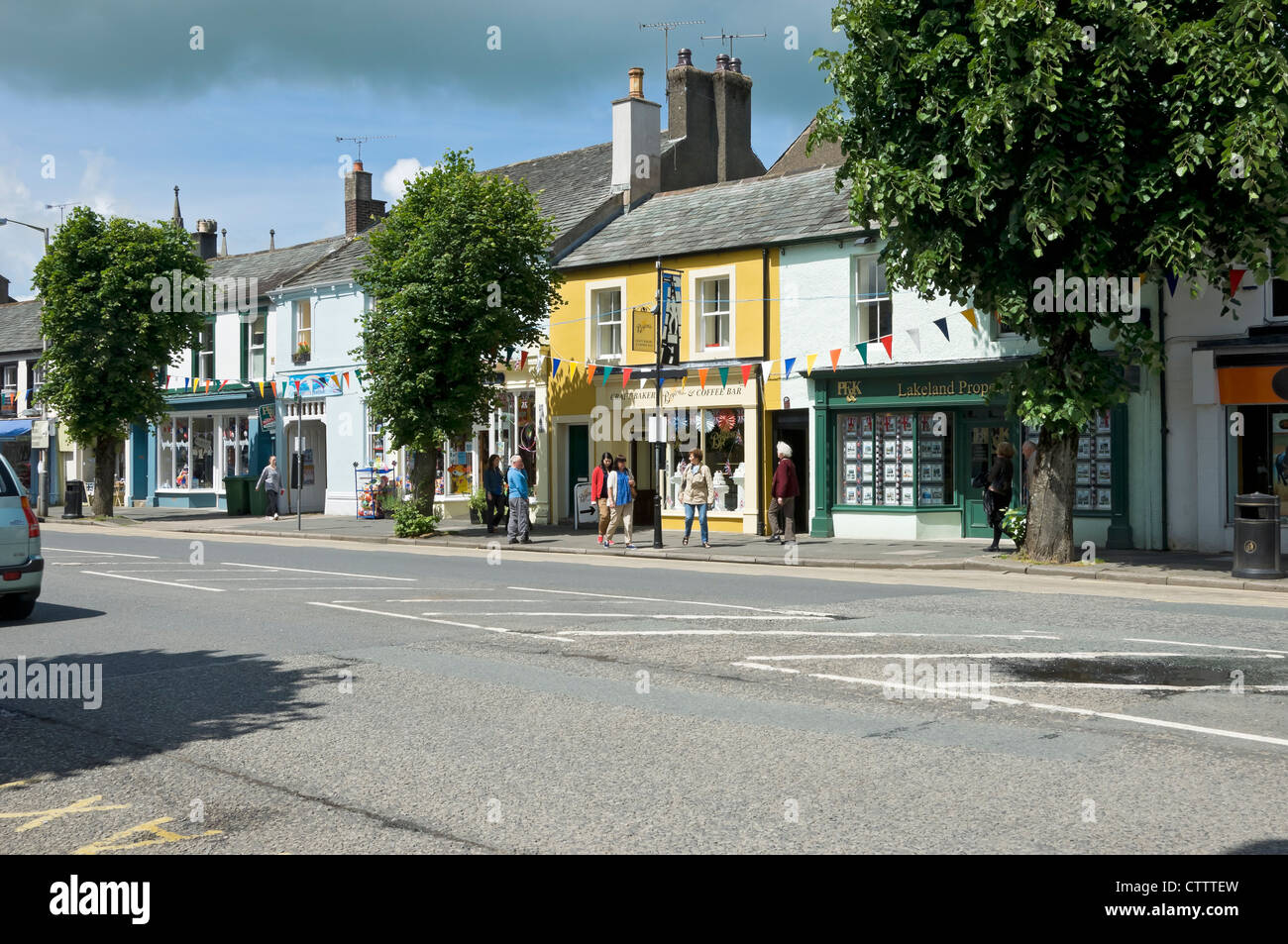 Store shops in Main Street in summer Cockermouth Cumbria England UK ...