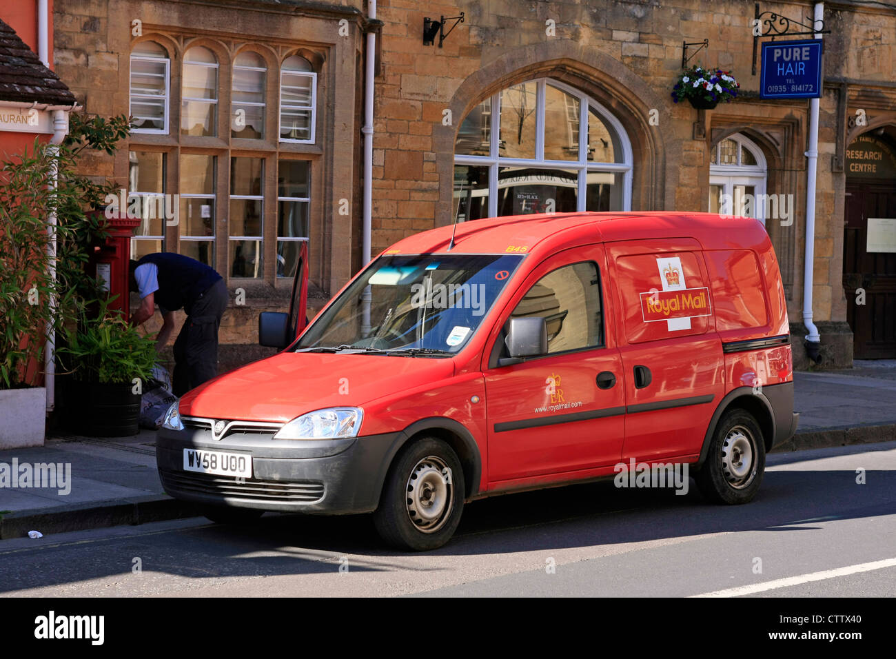 Royal Mail Postman on his route collecting mail from this postbox in ...