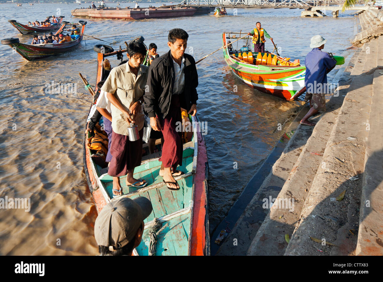 Ferry boats unloading at jetty on Yangon River, Yangon, Myanmar Stock ...