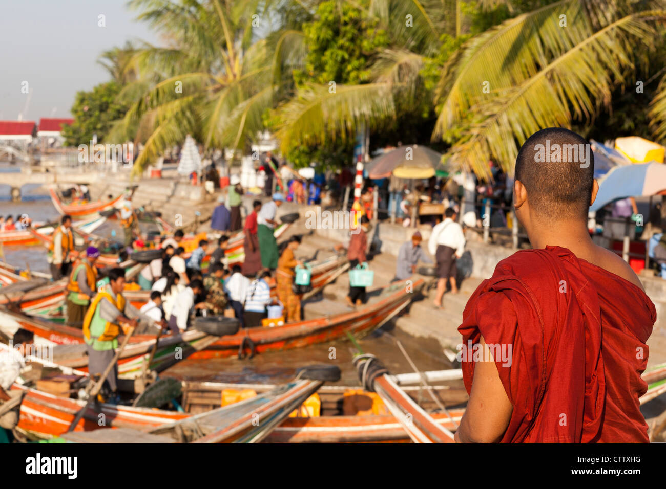 Monk and ferry boats at jetty on Yangon River, Yangon, Myanmar Stock ...