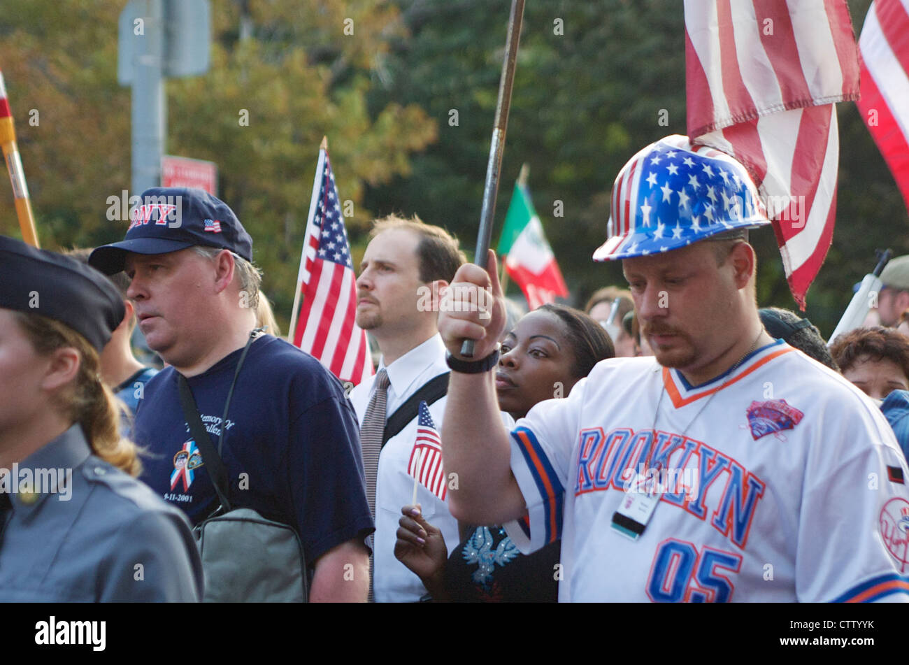 People listen to the one year anniversary observance of the September ...