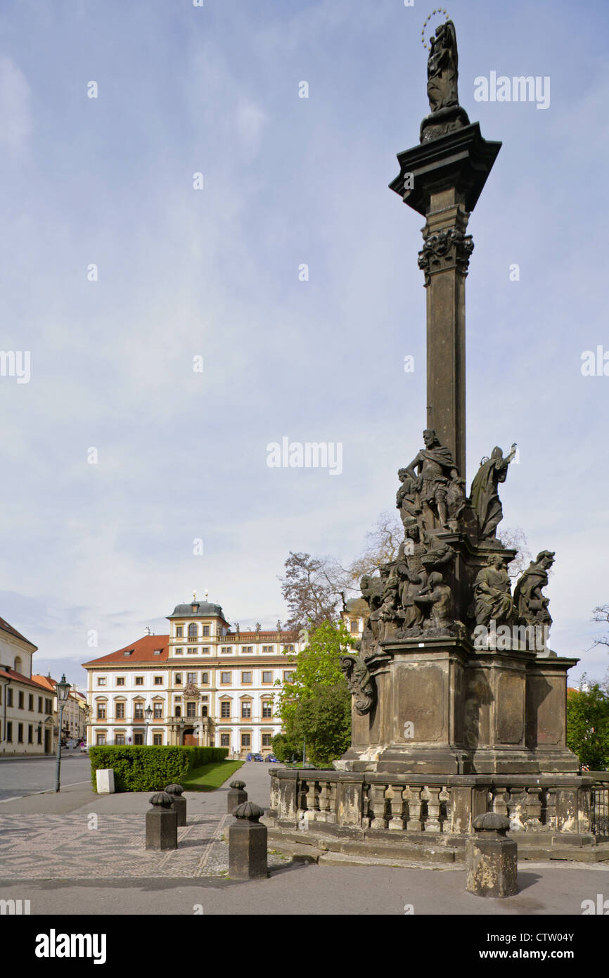 Old stone buildings and column in cobbled street near the castle ...