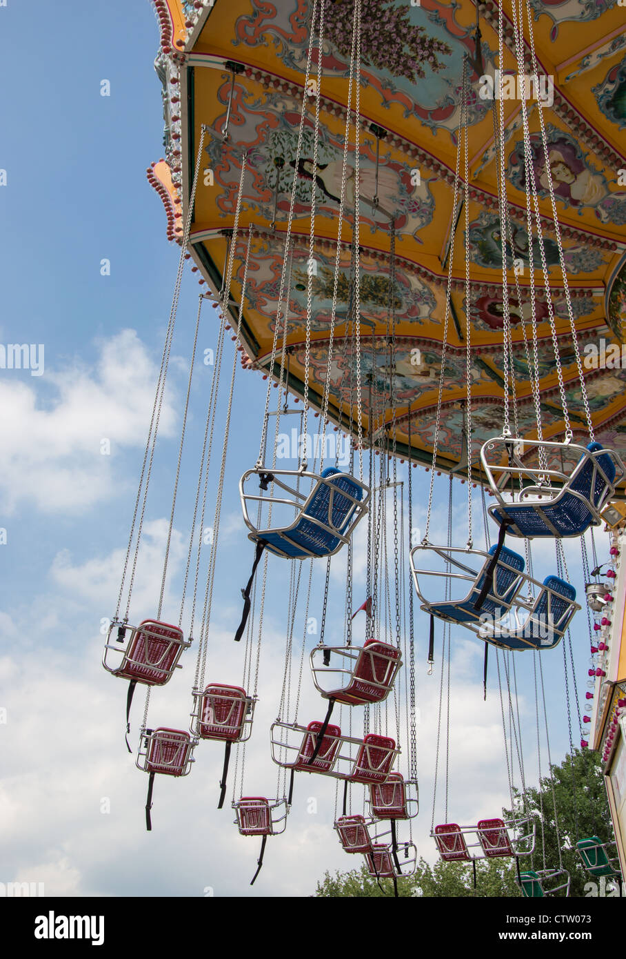 Chairoplane with clouds in the background Stock Photo - Alamy