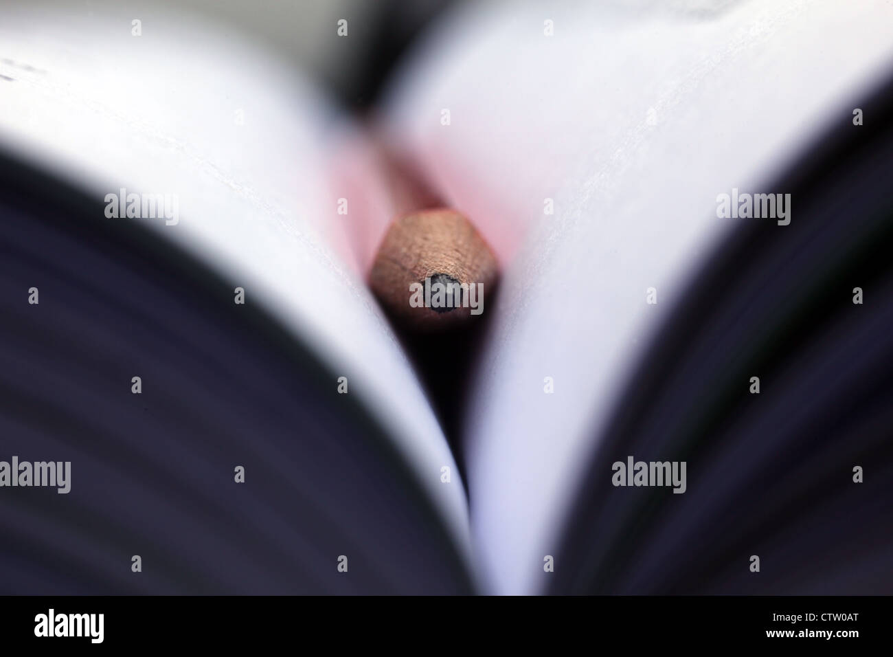 Open book with pencil Stock Photo - Alamy