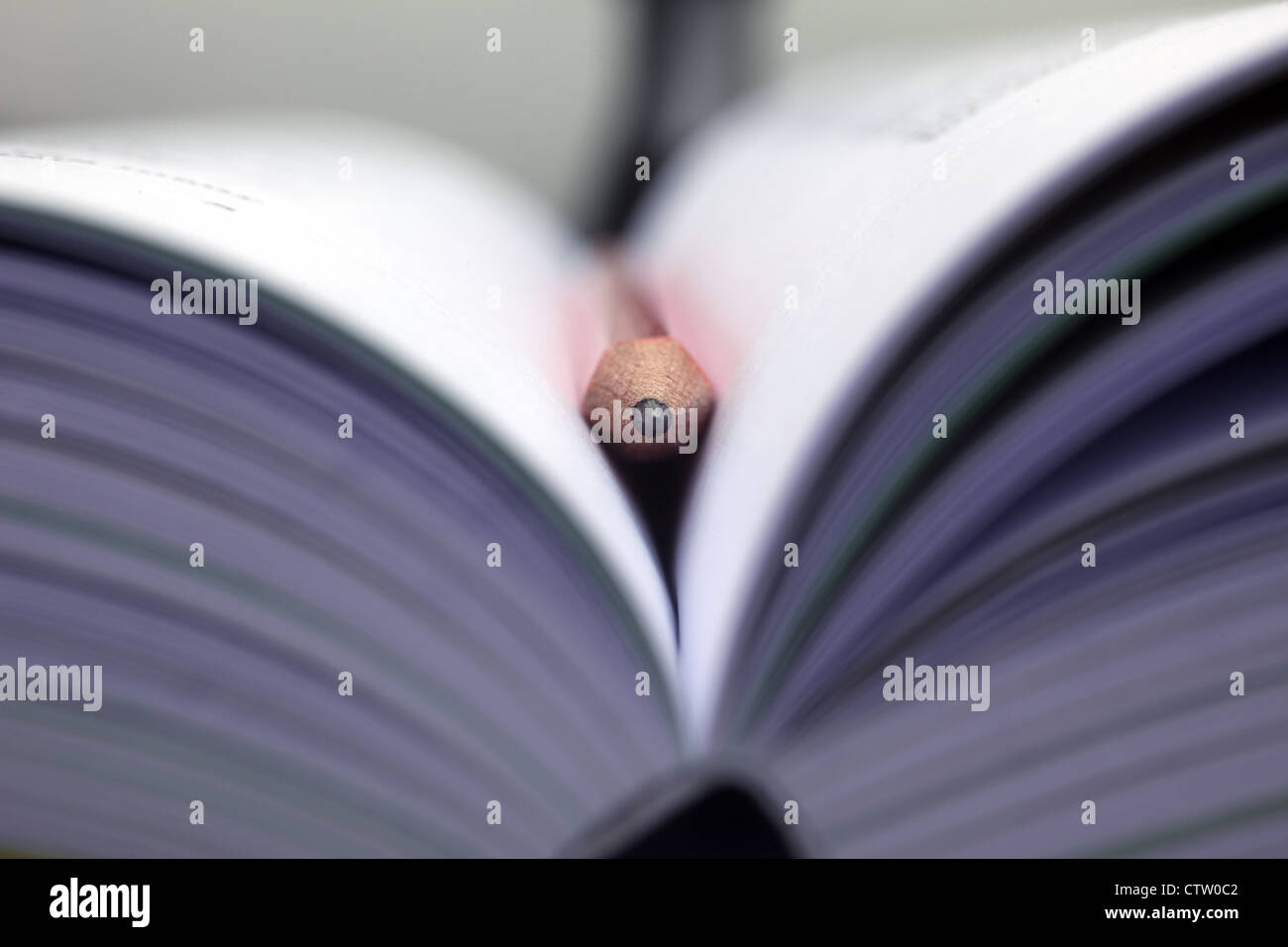 Open book with pencil Stock Photo - Alamy