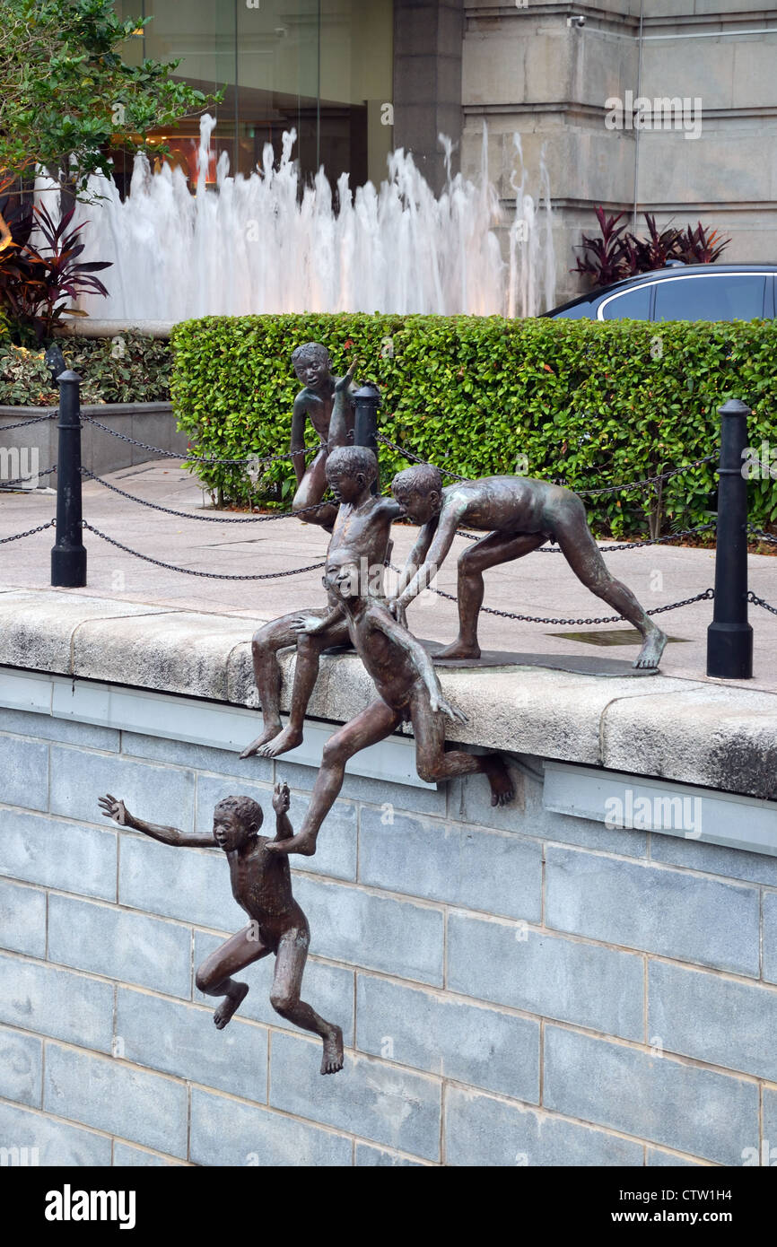 A statue at the Cavenagh Bridge, next to the Fullerton hotel, Singapore ...