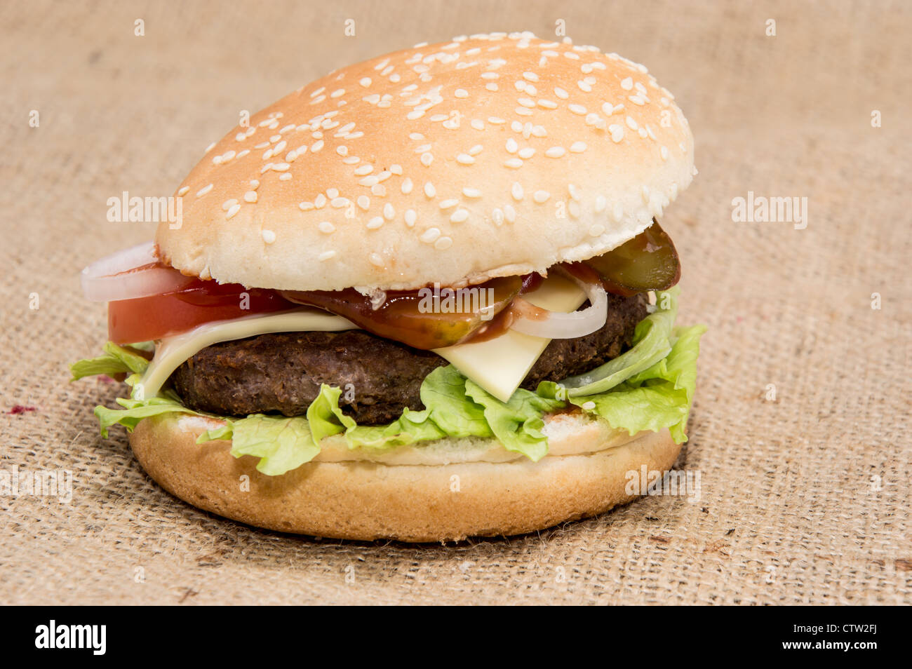 One single Cheeseburger on rustic background Stock Photo - Alamy