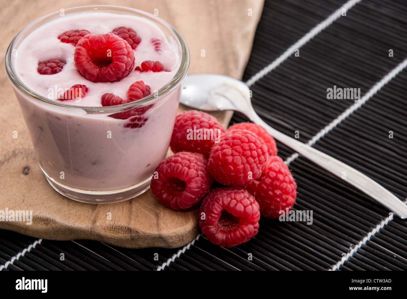Raspberry Yogurt with fresh fruits on black background Stock Photo - Alamy