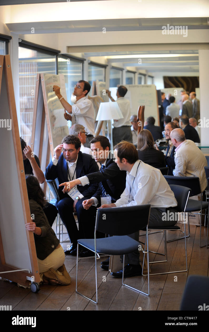 Delegates in discussion during a brainstorming session on Mobility ...