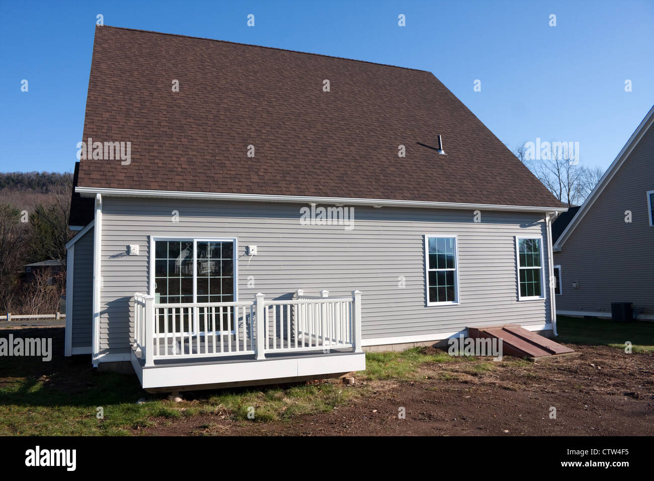 Rear view of a modern custom built house newly constructed with a walk ...