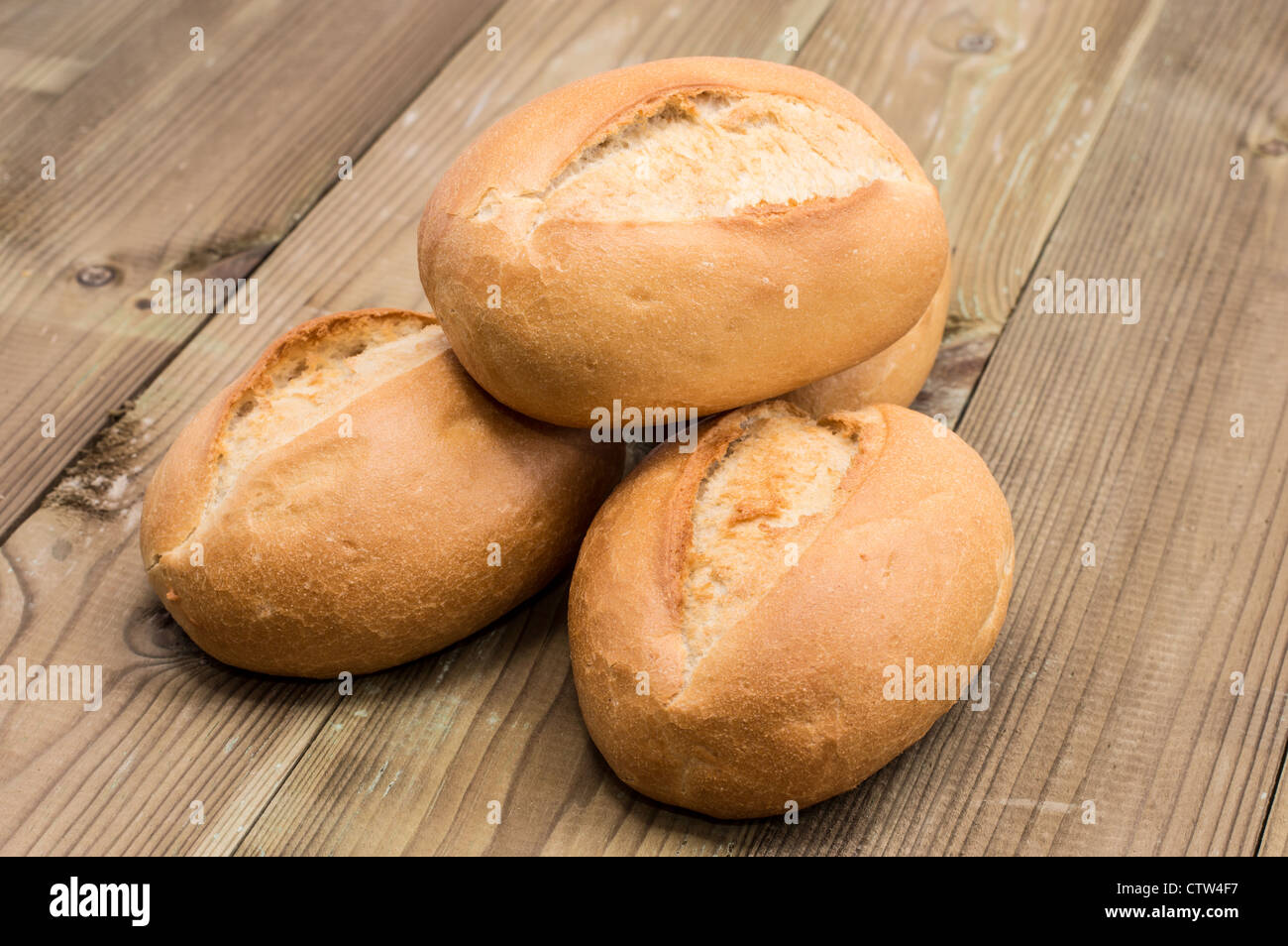 Three Buns on a wooden background Stock Photo - Alamy